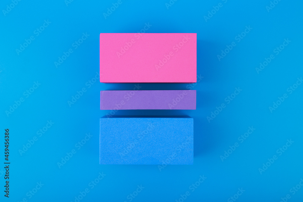 Flat lay with bisexual pride flag made of colorful blocks on blue ...
