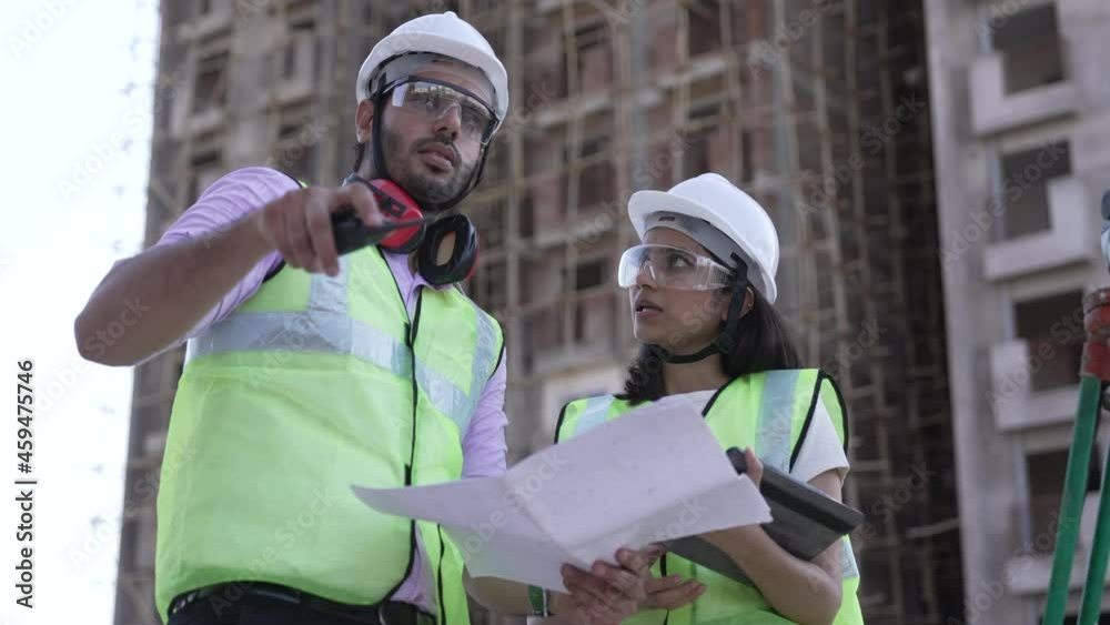 Two Indian man and woman Civil Engineers work at Construction Site ...
