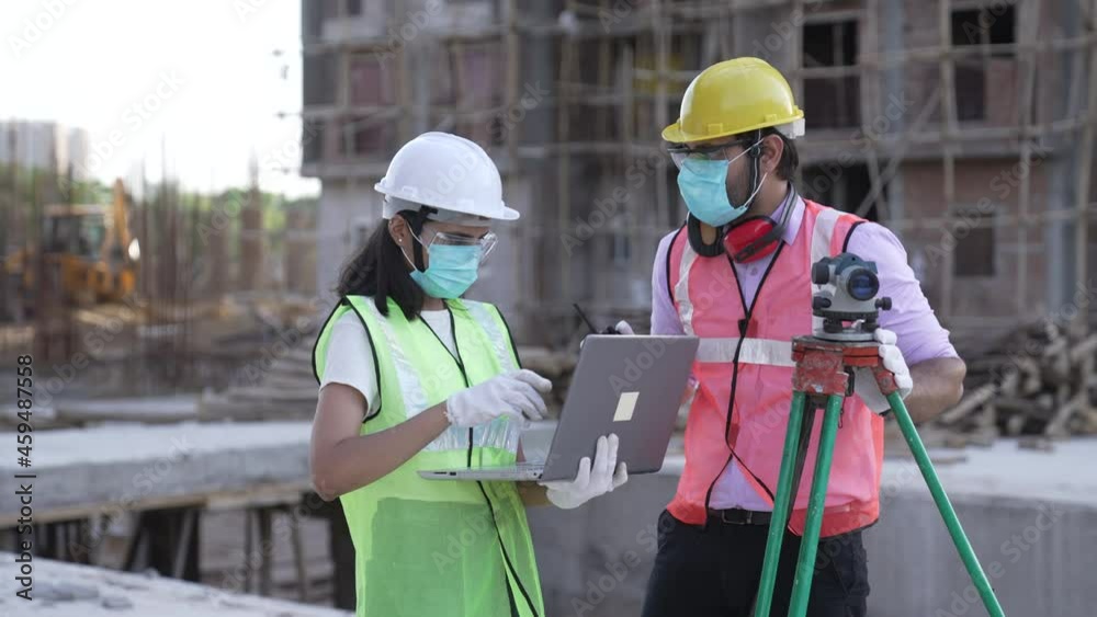 Two Indian man and woman Civil Engineers with face mask work at ...