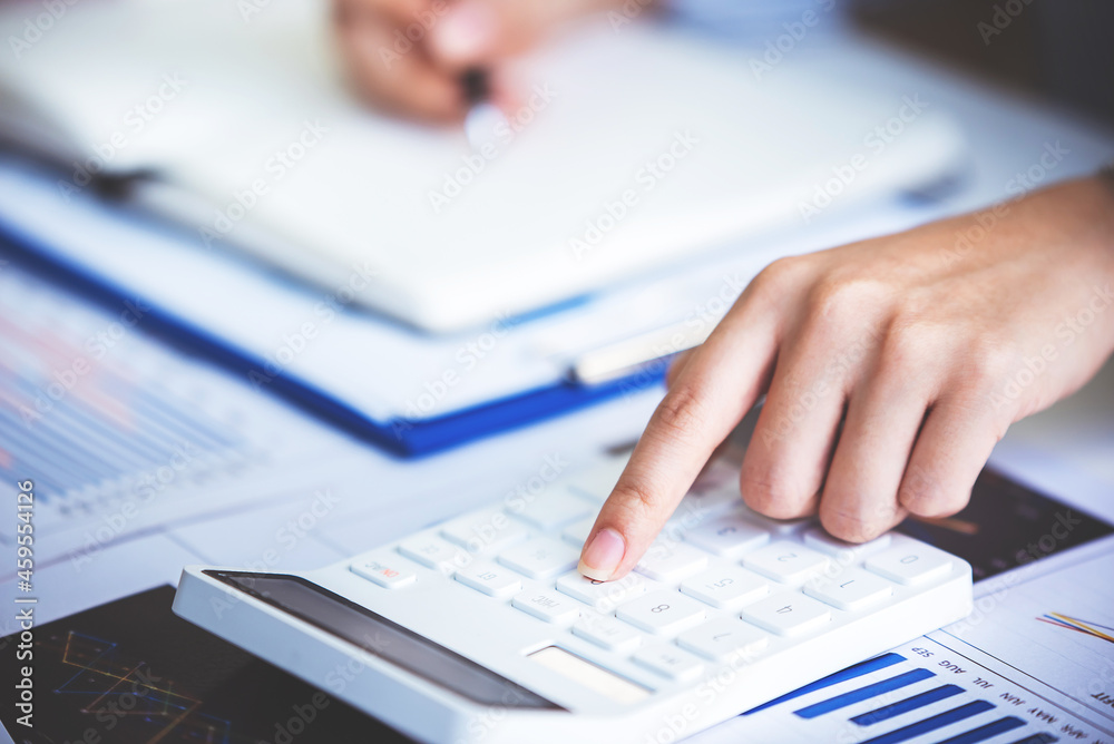 business woman or accountant who are using a calculator to calculate ...
