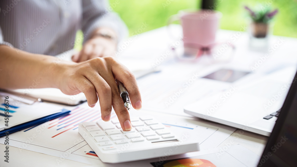 business woman or accountant who are using a calculator to calculate ...