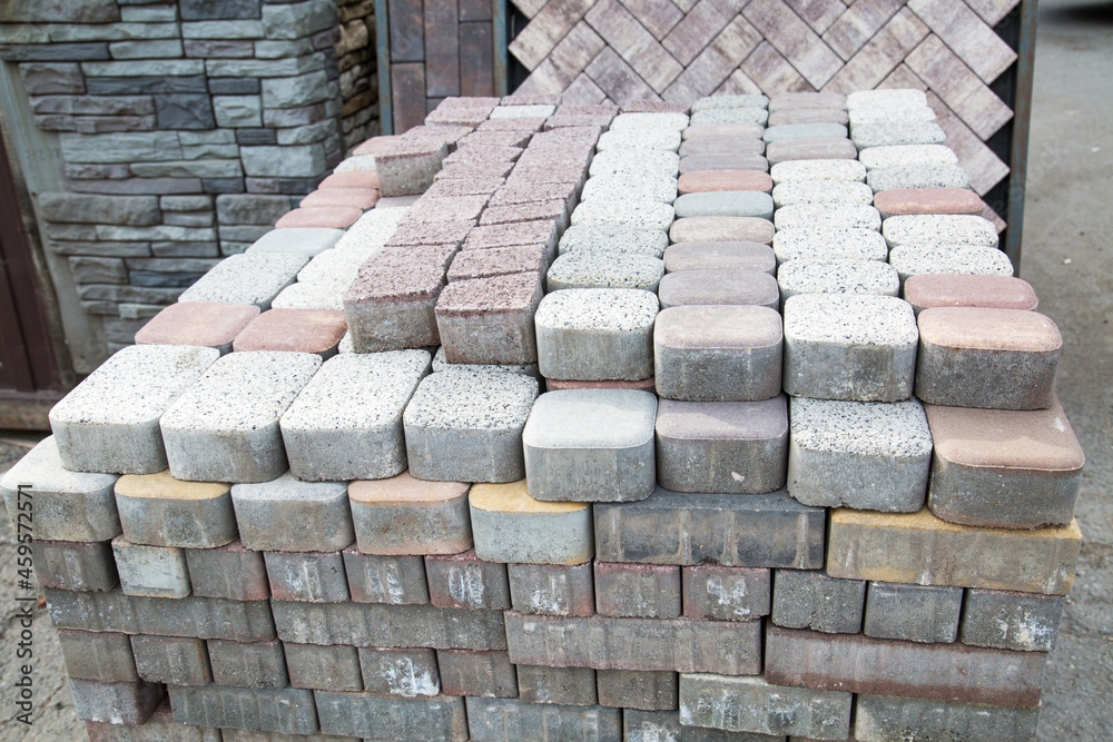 A stack of oval and rectangular paving stones of light lilac, beige ...
