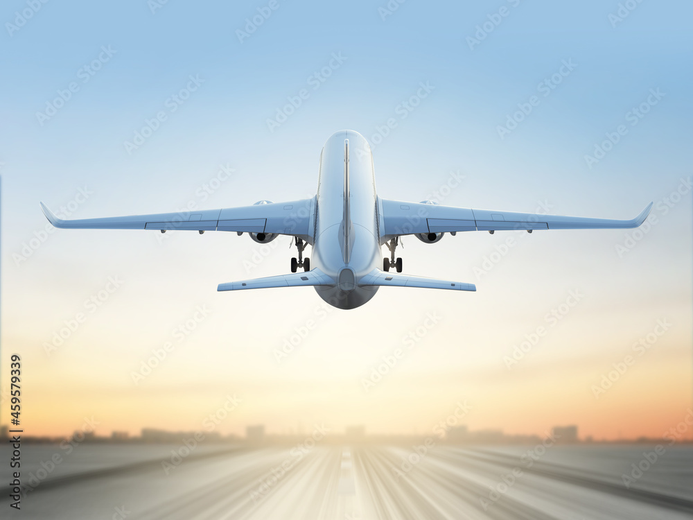 Commercial aircraft above runway on evening sky background with ...
