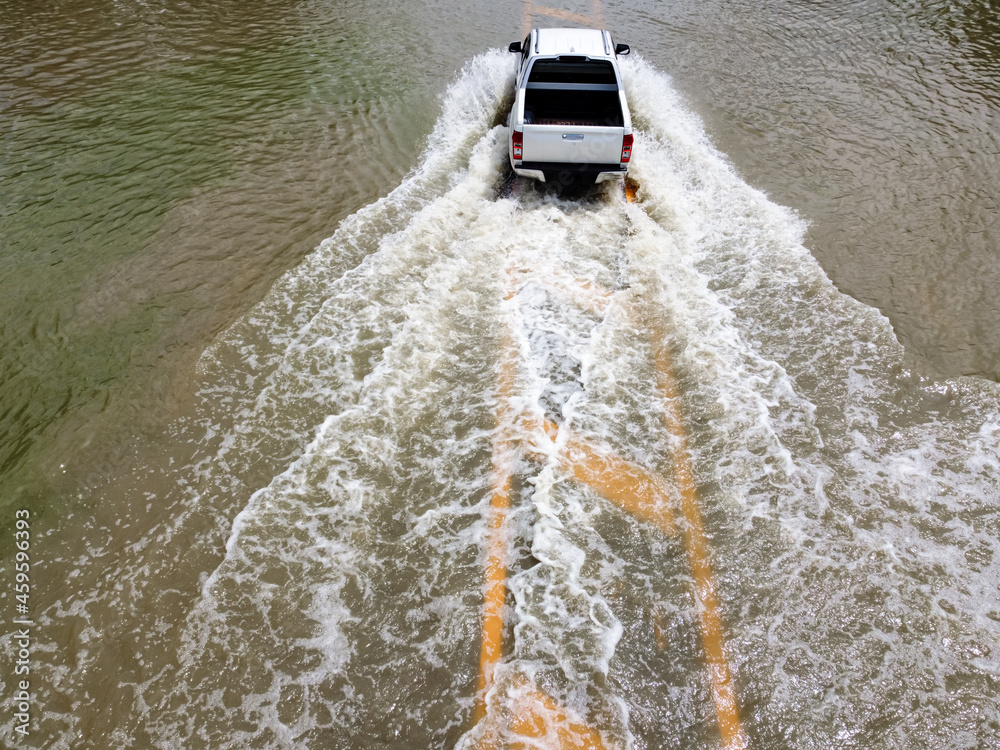 Flooded roads, people with cars running through. Aerial drone ...