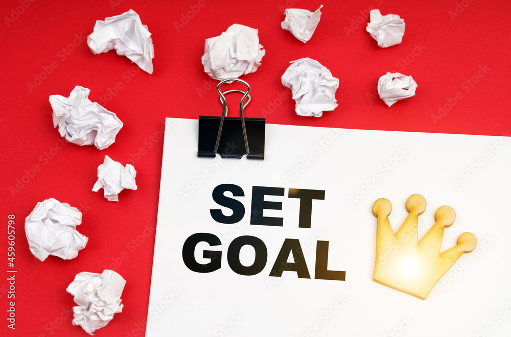 On a red background in crumpled paper and a sheet with the inscription ...