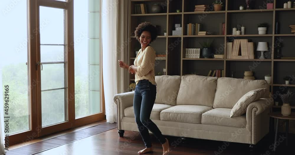 Motion is life. Happy gen z black woman dancing modern dance in light ...