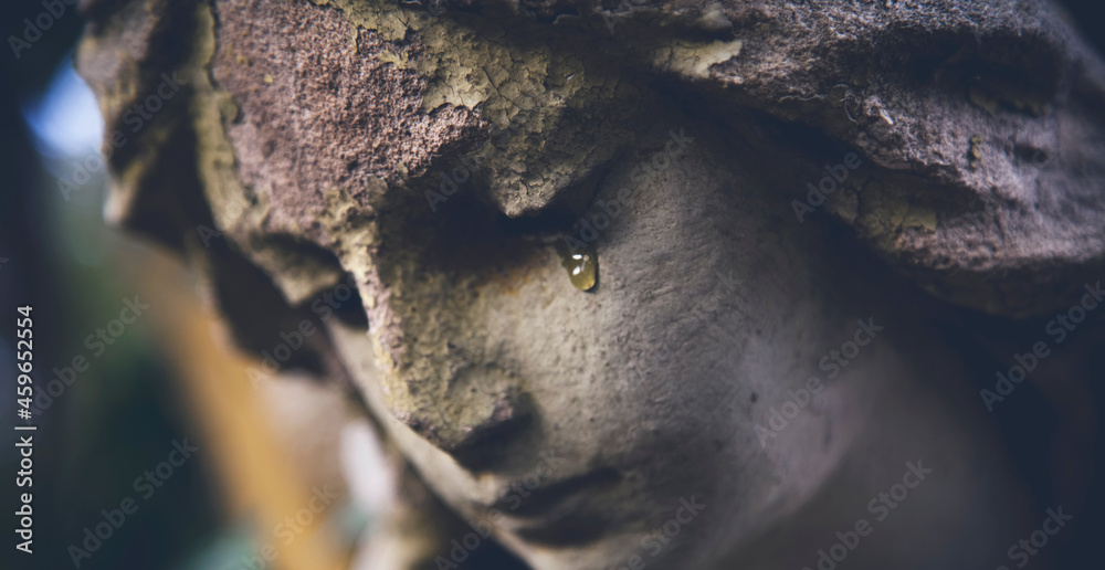Angel's tears. Close up fragment of ancient statue of angel. The ...