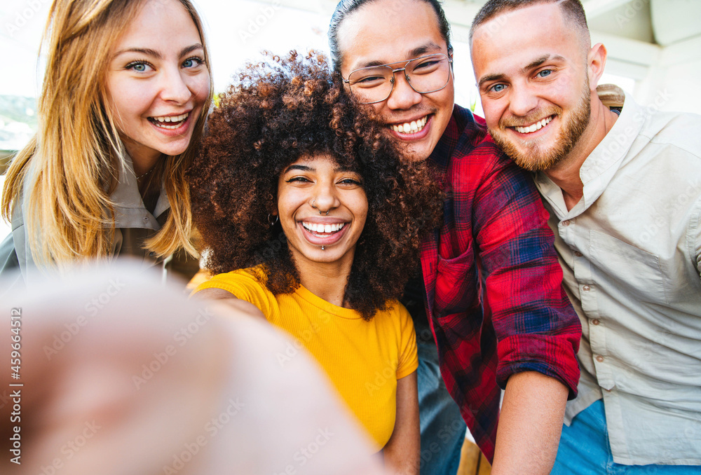 Multicultural happy friends having fun taking group selfie portrait ...