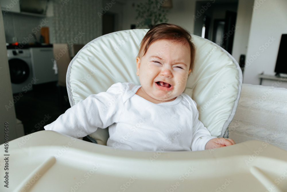 Angry little baby with sad expressions, screaming and crying. at home ...