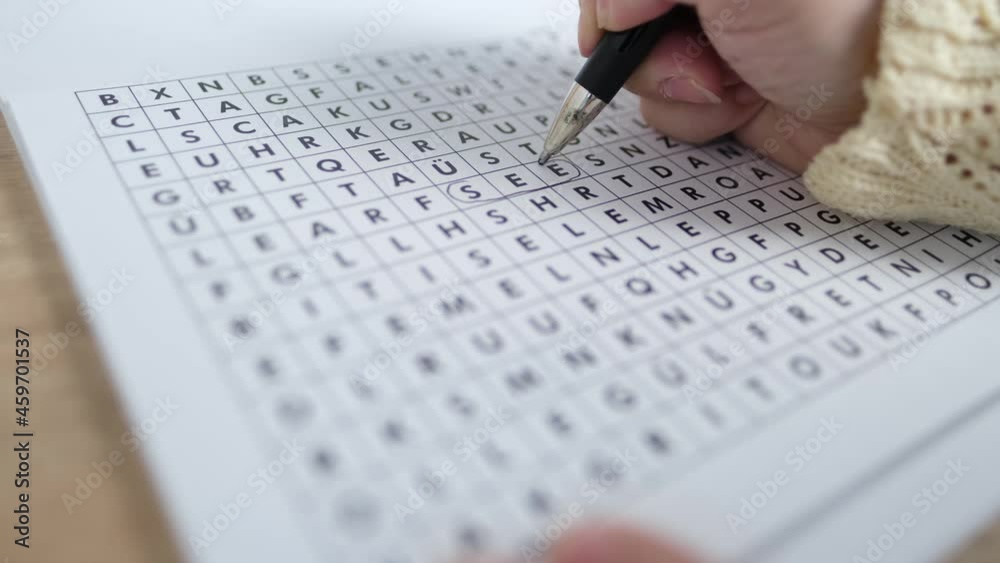 female hand close-up draws lines on paper, spell out and spell word in ...