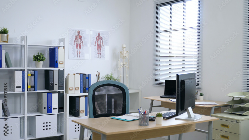 interior of the modern bright clinic office room with computers, human ...