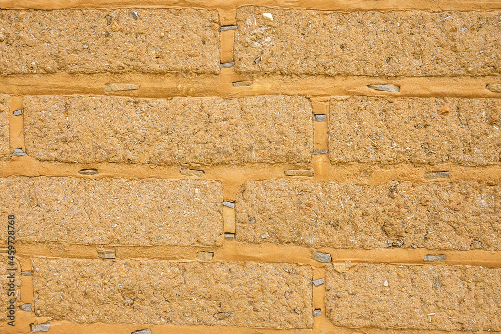 Detail of old adobe brick wall for background or texture. Mud brick ...