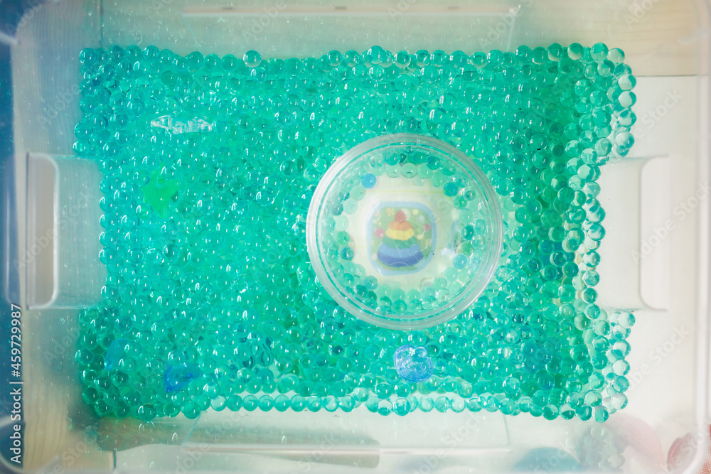 Baby play sensory hydrogel box, kids hands touch, play with blue water ...