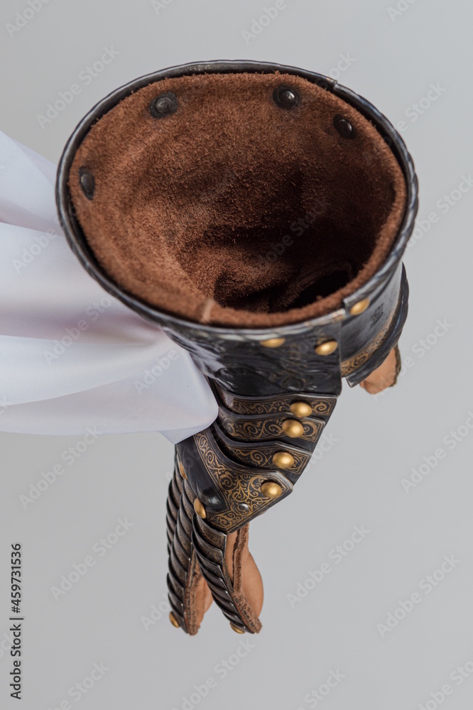 Medieval knightly brown plate gauntlet from Italian armor, in the form ...