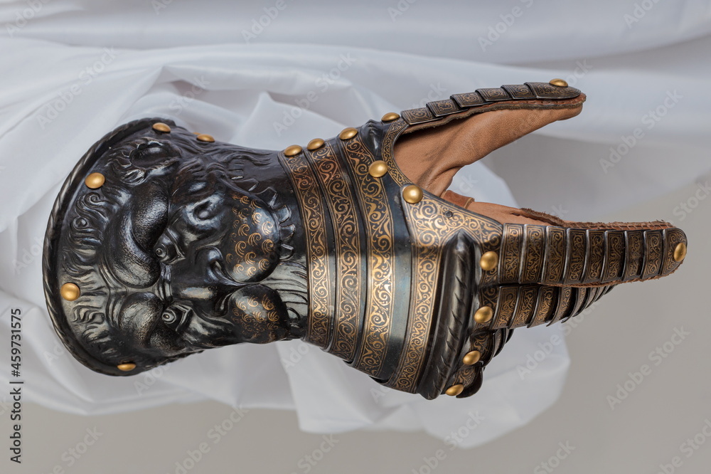 Medieval knightly brown plate gauntlet from Italian armor, in the form ...