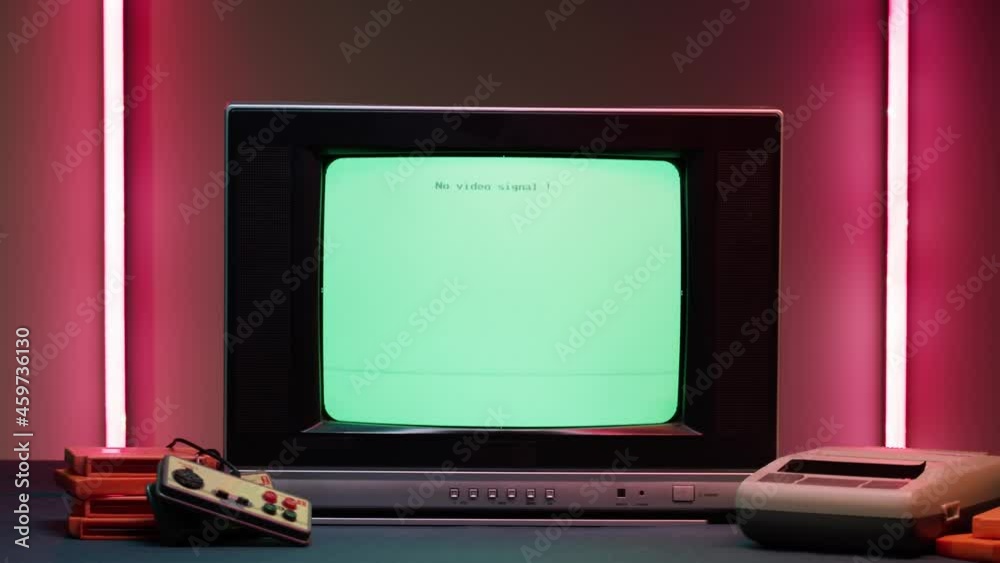 Old television with blue screen on red neon background. Close-up of ...