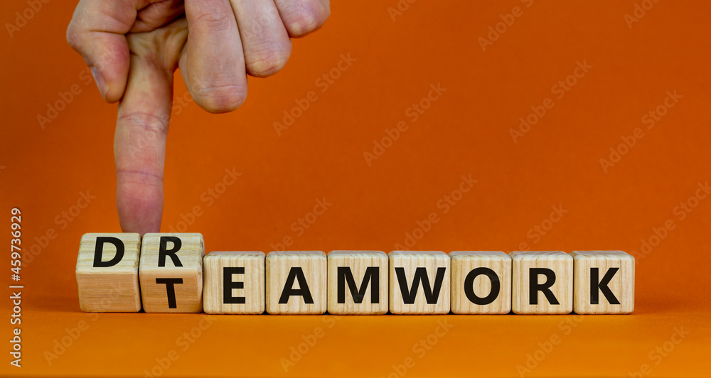 Teamwork and dream work symbol. Businessman turns wooden cubes and ...