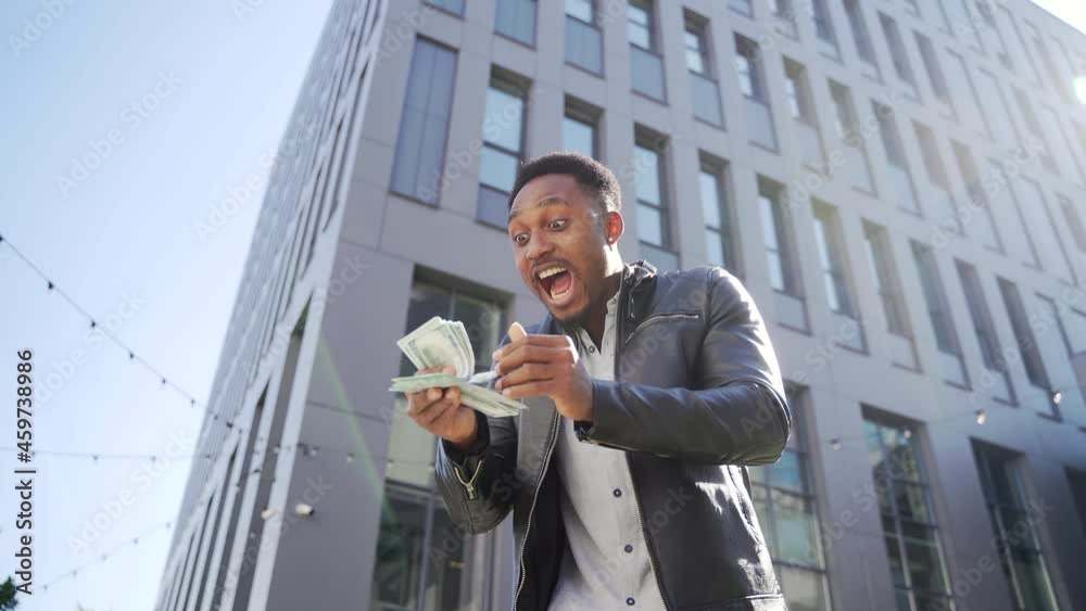 Vidéo Stock Happy successful African American guy counts, waves, throws ...