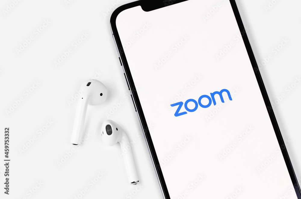 Zoom mobile logo app on screen smartphone iPhone with AirPods. Zoom ...