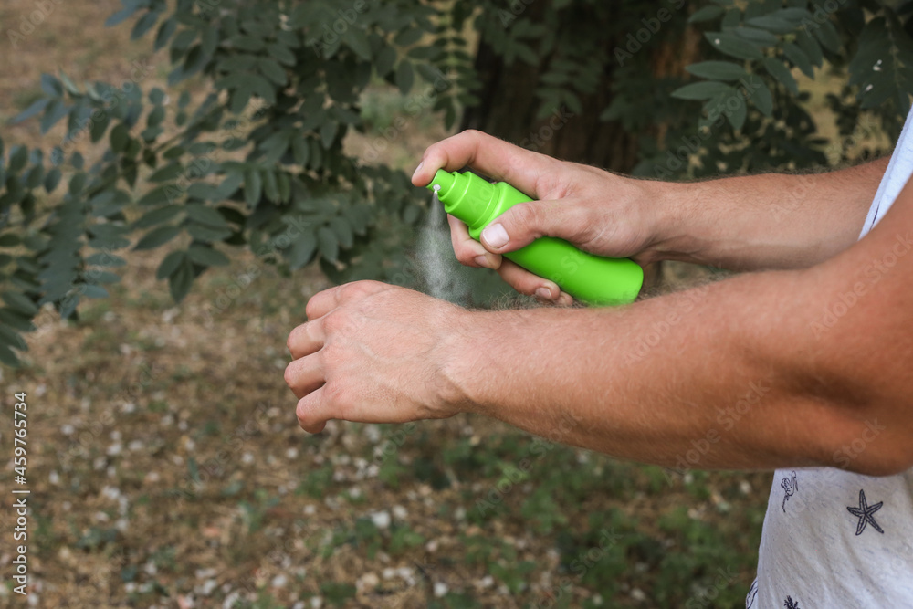 Mosquito repellent. Men using insect spray outdoors, insect bites ...