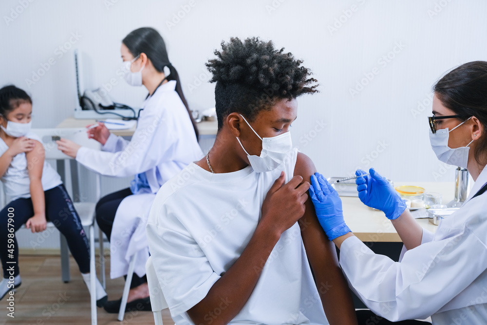 Professional nurse giving flu or antiviral vaccine to people in ...