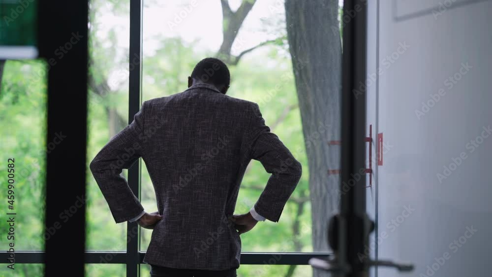 Back view of overwhelmed African American young man in suit throwing ...