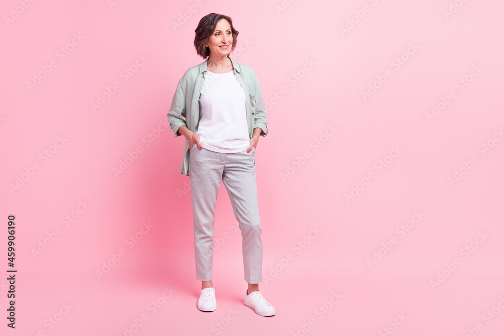 Full body portrait of satisfied aged people arms in pockets look ...