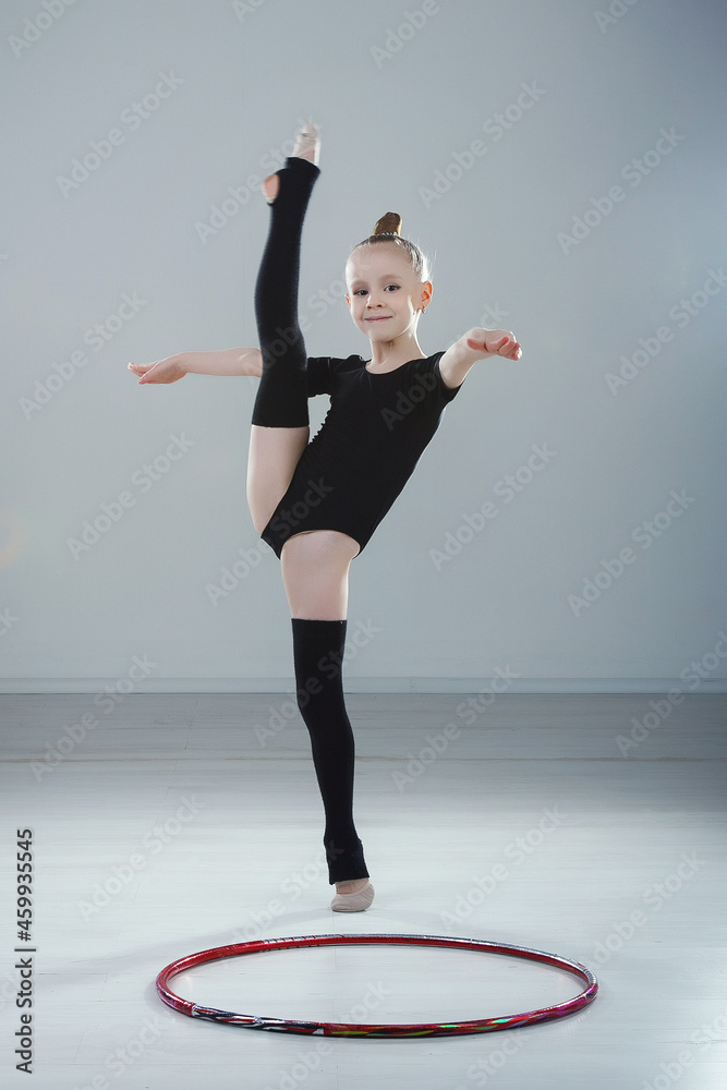 Image of flexible little girl doing vertical split with hula hoop Stock ...
