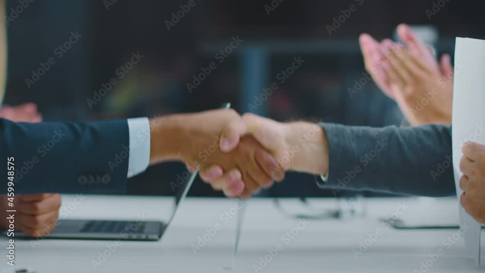 Handshaking over desk in office. People of different races. Clapping ...