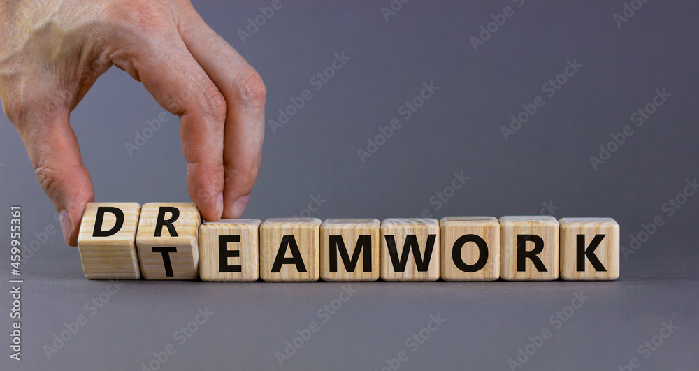 Teamwork and dream work symbol. Businessman turns wooden cubes and ...
