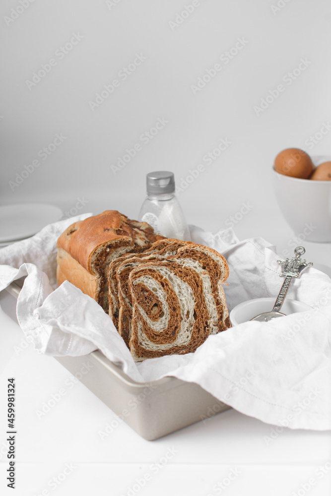 Tall swirl sandwich bread in bread pan,slices of white and brown spiral ...