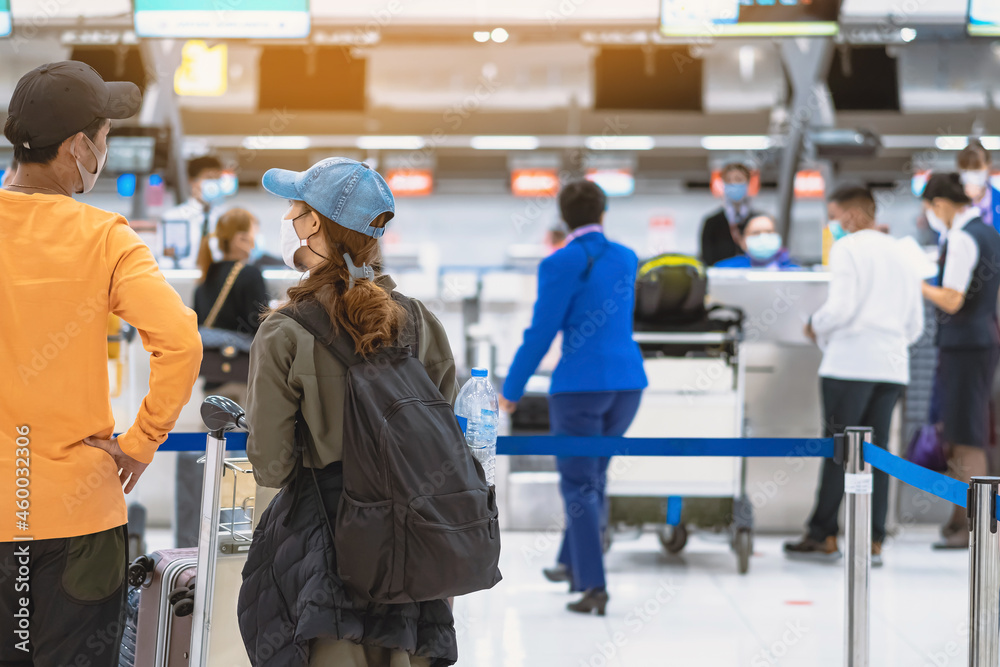 Back view of airline passenger wear face mask to prevent Corona virus ...