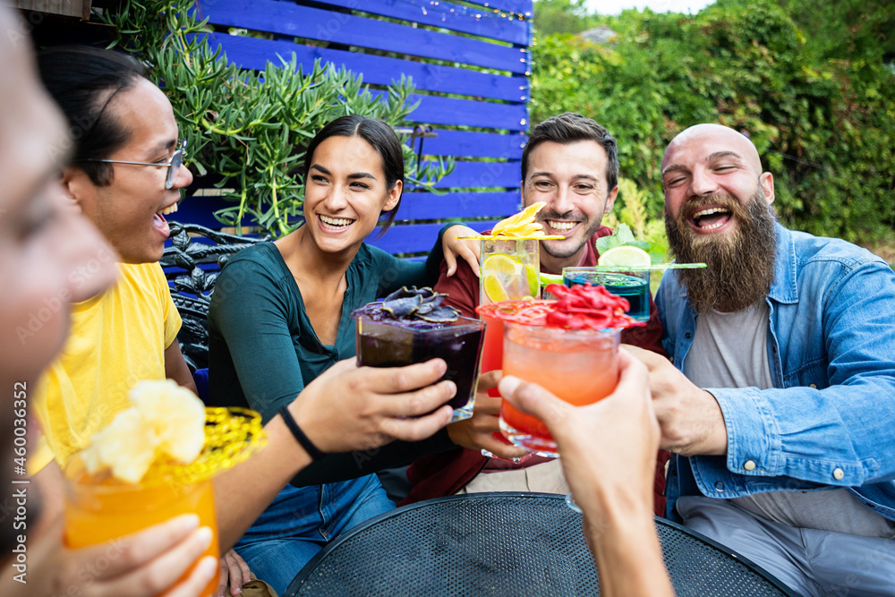 Happy trendy friends celebrating together while cheering with ...