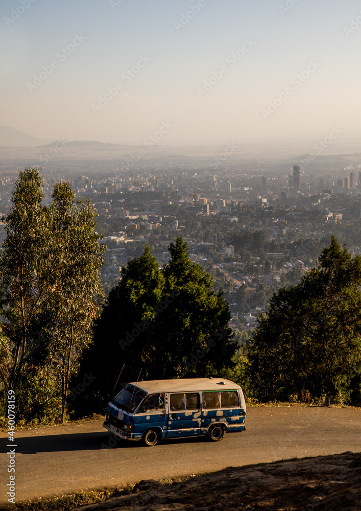Bus passing in front of a panoramic view of the town seen from Entoto ...