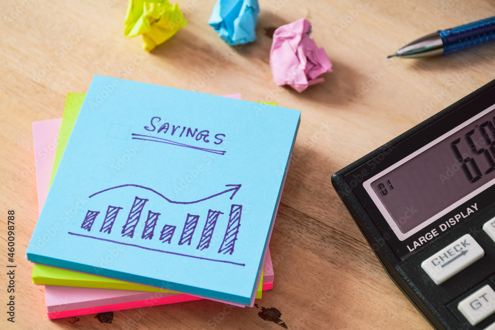 Savings handwritten text and bar chart with up arrow on sticky note ...