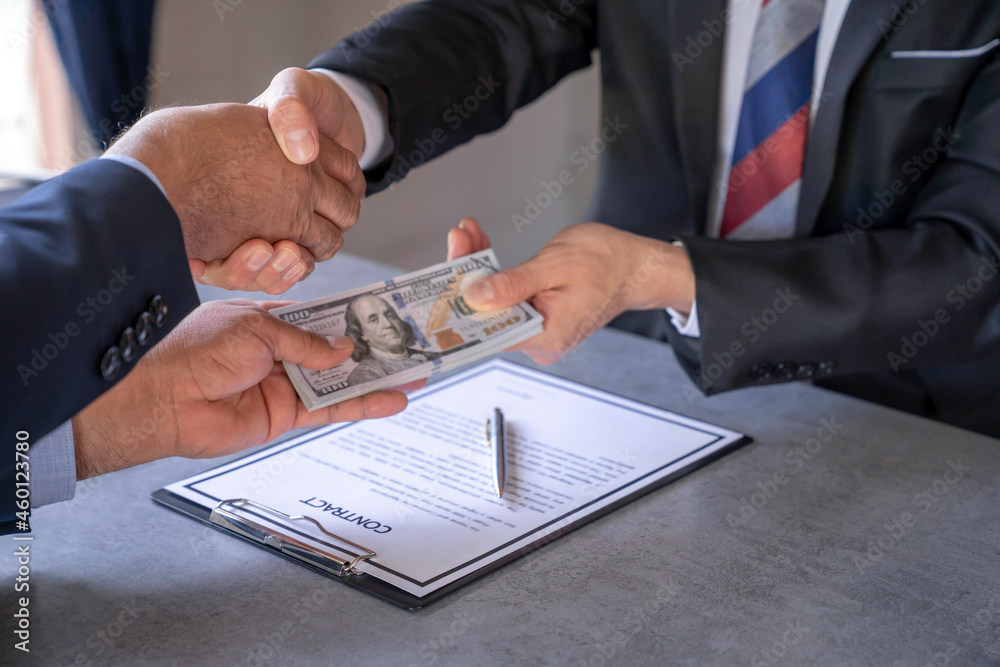 Businessmen or politicians agree to accept bribes. by shaking hands To ...