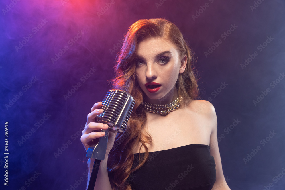 Cropped portrait of young female jazz singer isolated over gradient ...