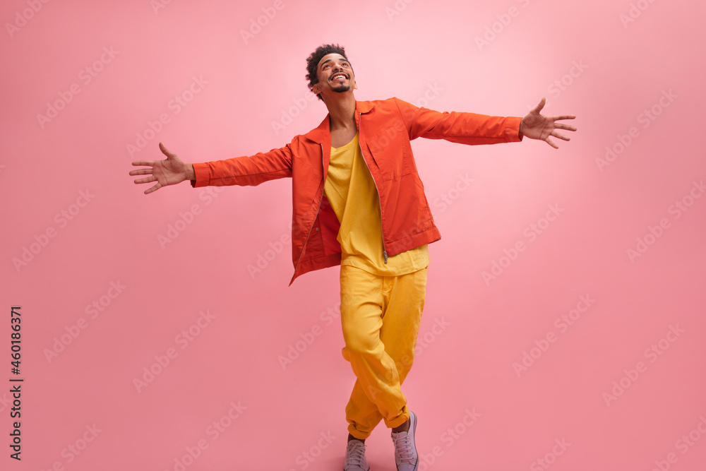 Full length African young man with open arms smiles genuinely with copy ...