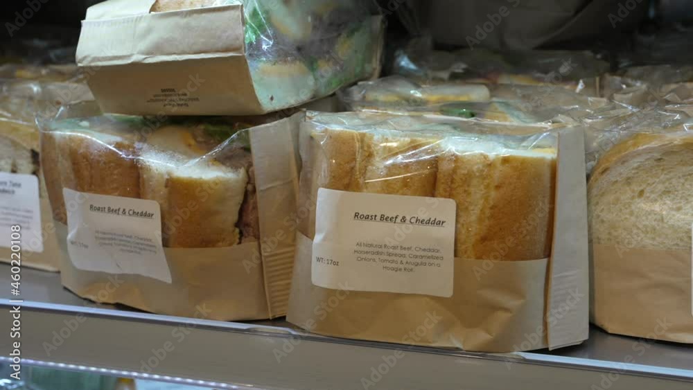 This panning video shows a display at a convenient market of rows of ...