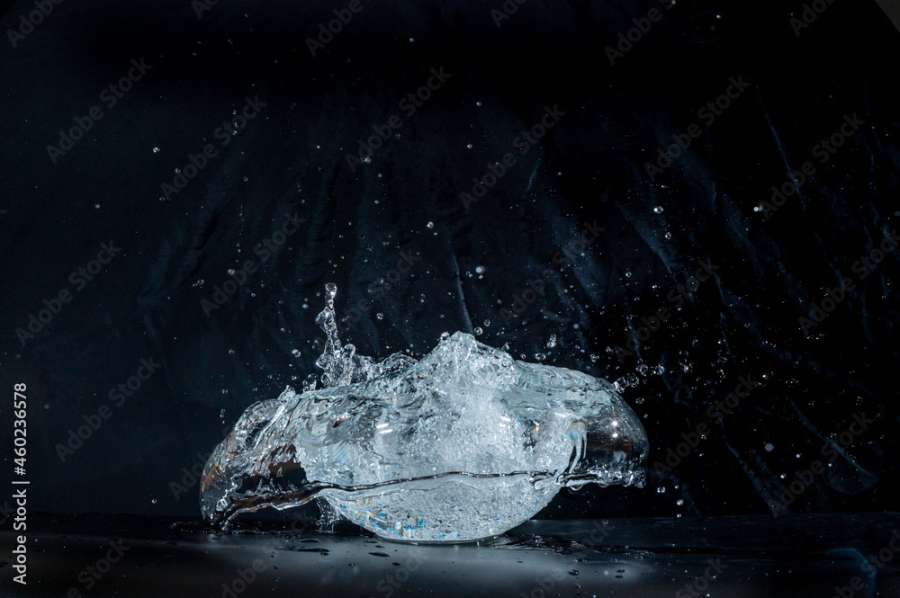 Explosion of water on a black background. Splashes in different ...