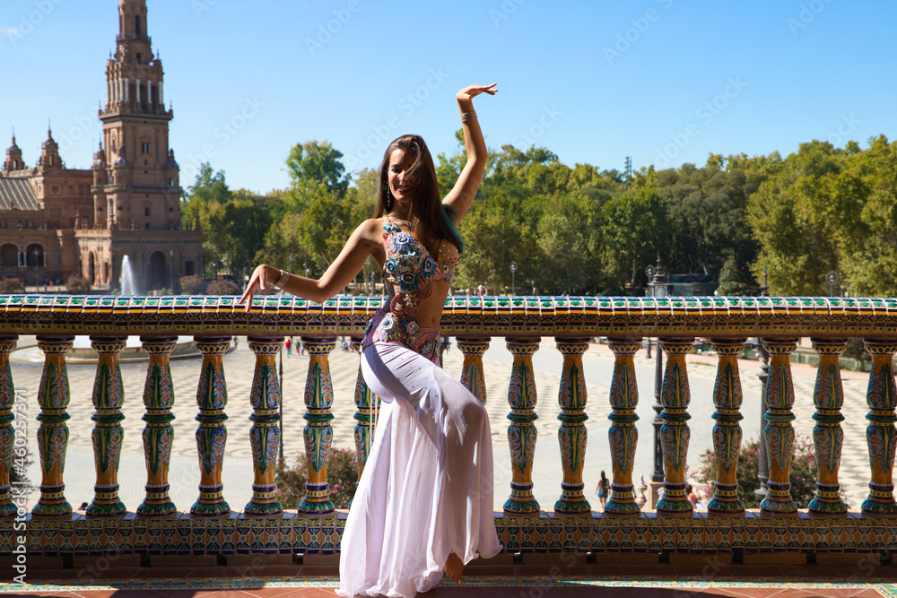 beautiful young belly dancer is posing for the camera in a photo shoot ...