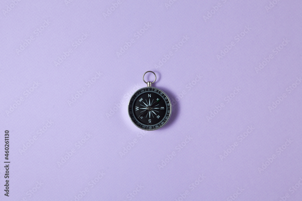 Compass on purple background. Concept signs symbols. Tool for travel ...