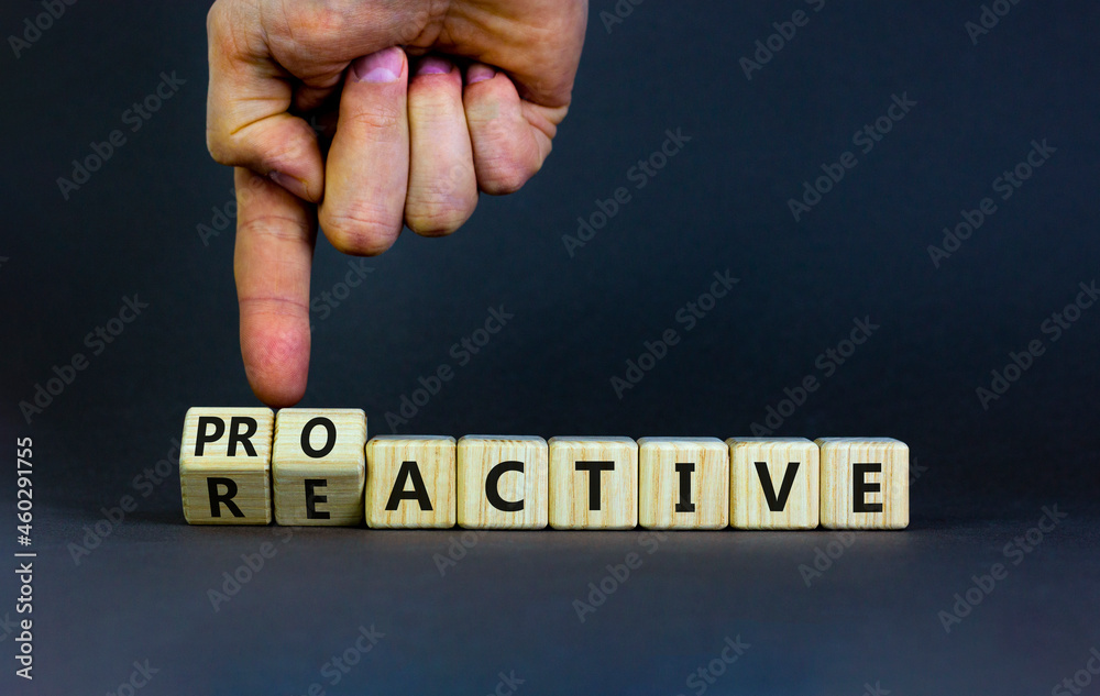 Reactive or proactive symbol. Businessman turns wooden cubes and ... Reactive or proactive symbol. Businessman turns wooden cubes and ...