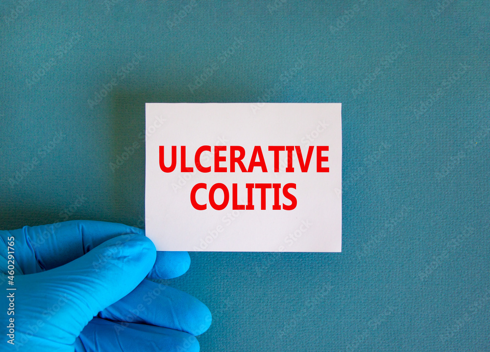 Ulcerative colitis symbol. White note with words Ulcerative colitis ...