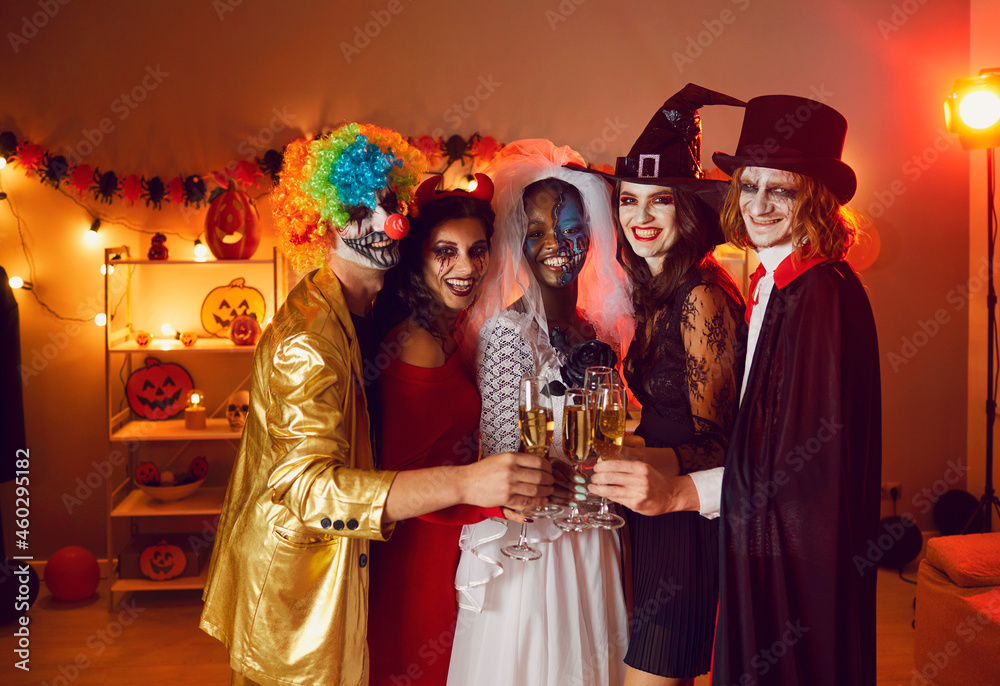 Diverse group of happy young people drinking and having fun at ...