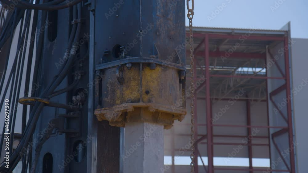 Excavation at a construction site, diesel pile driving machine with ...