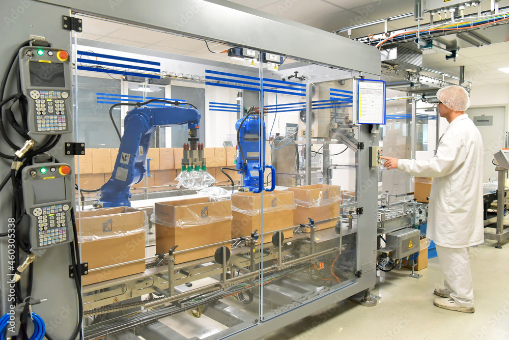medical products manufacturing in a modern factory - worker operates ...