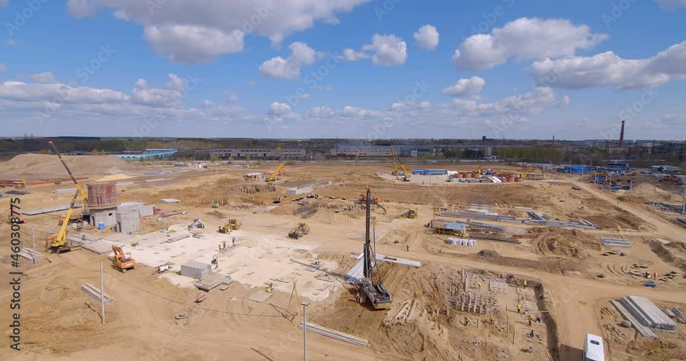 At the construction site where a new, modern plant is being built, a ...