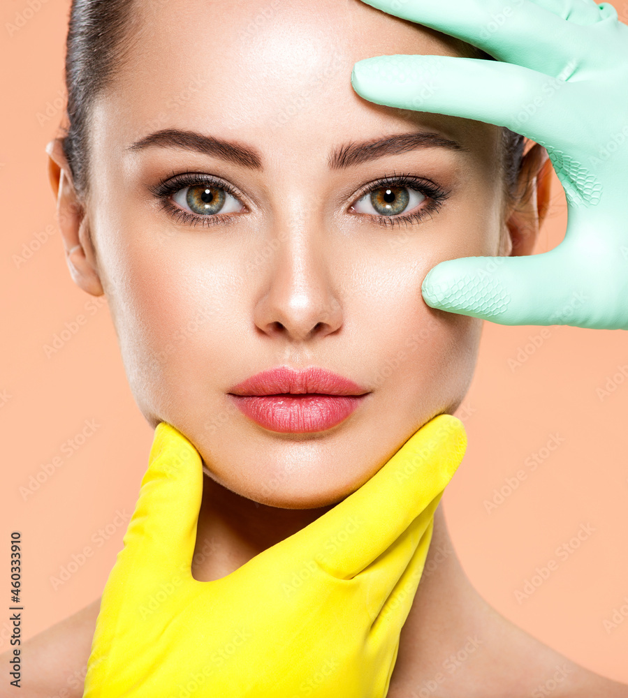 Face skin check before plastic surgery. Beautician touching young woman ...