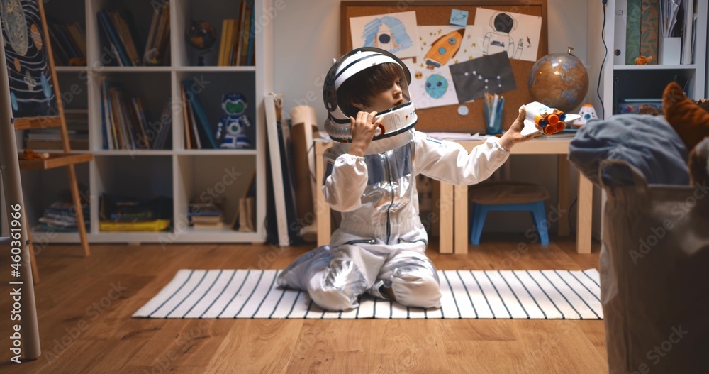 Childhood dreams about future. Happy little boy in astronaut suit ...